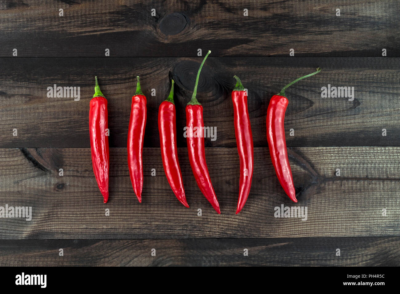 chilli peppers on wooden background Stock Photo - Alamy