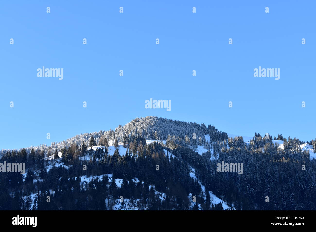Moon going down over an alpine mountain Stock Photo - Alamy