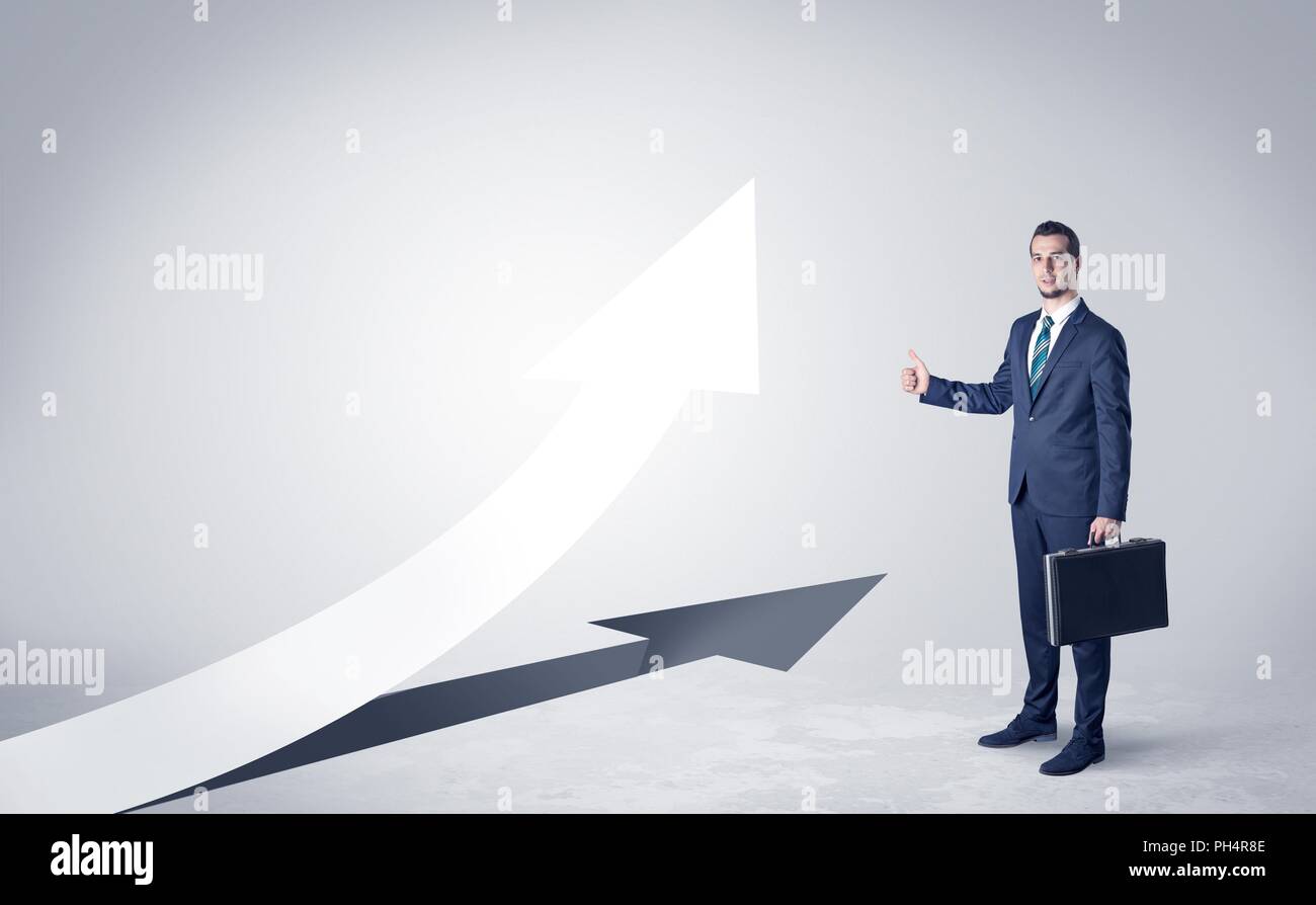 Young businessman hitchhiking with progressive arrow concept and ...