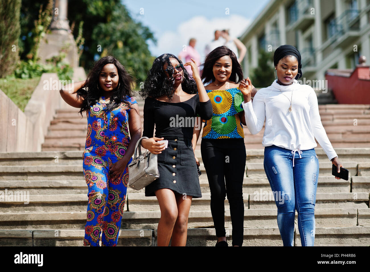 Group of four african american girls walking at stairs of city Stock ...
