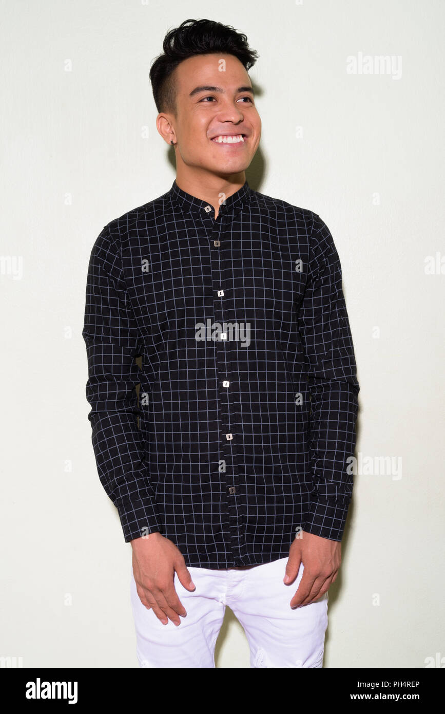 Young multi-ethnic man wearing smart clothing against white background ...