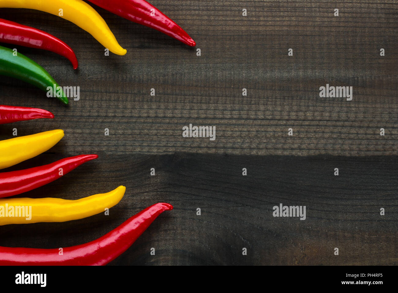 chilli peppers on wooden background Stock Photo - Alamy