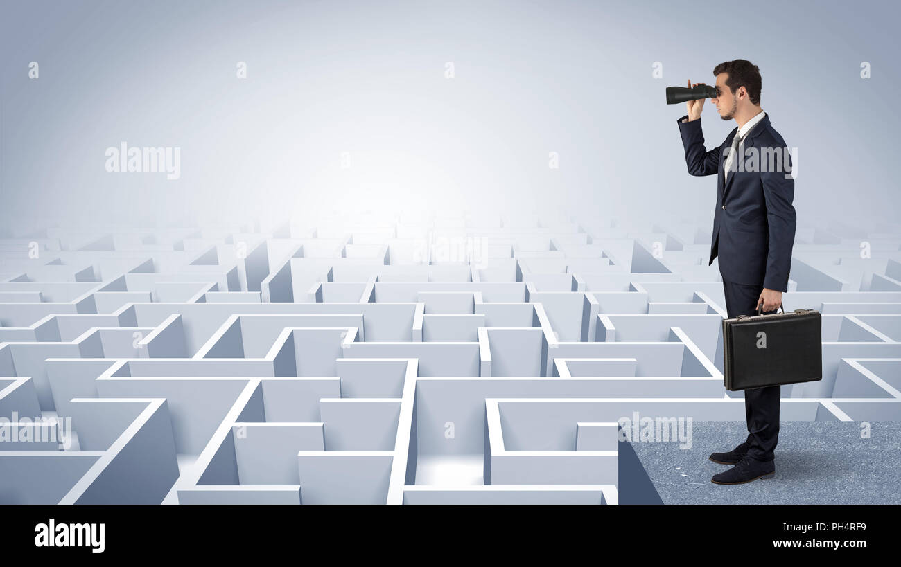 Businessman standing on maze and looking forward to the future concept ...