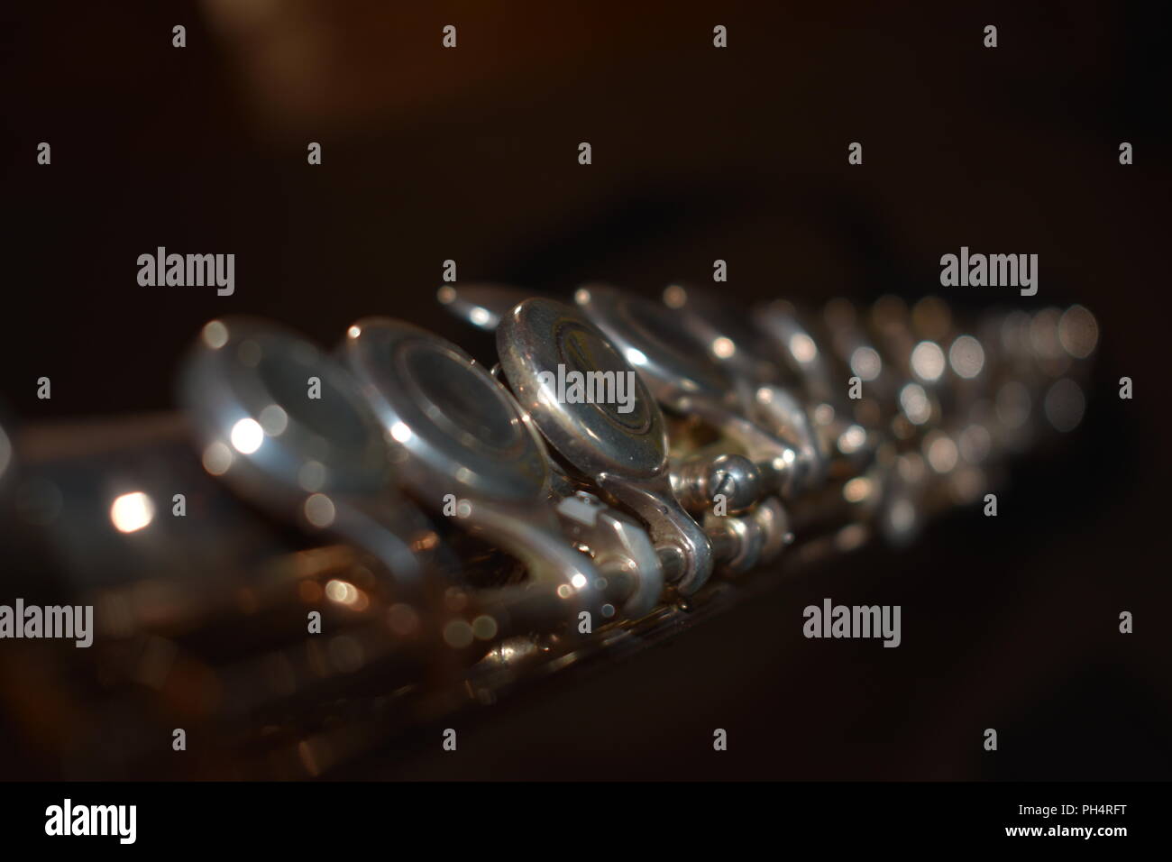 Close-up of a flute, showing the keys with a bokeh effect Stock Photo ...