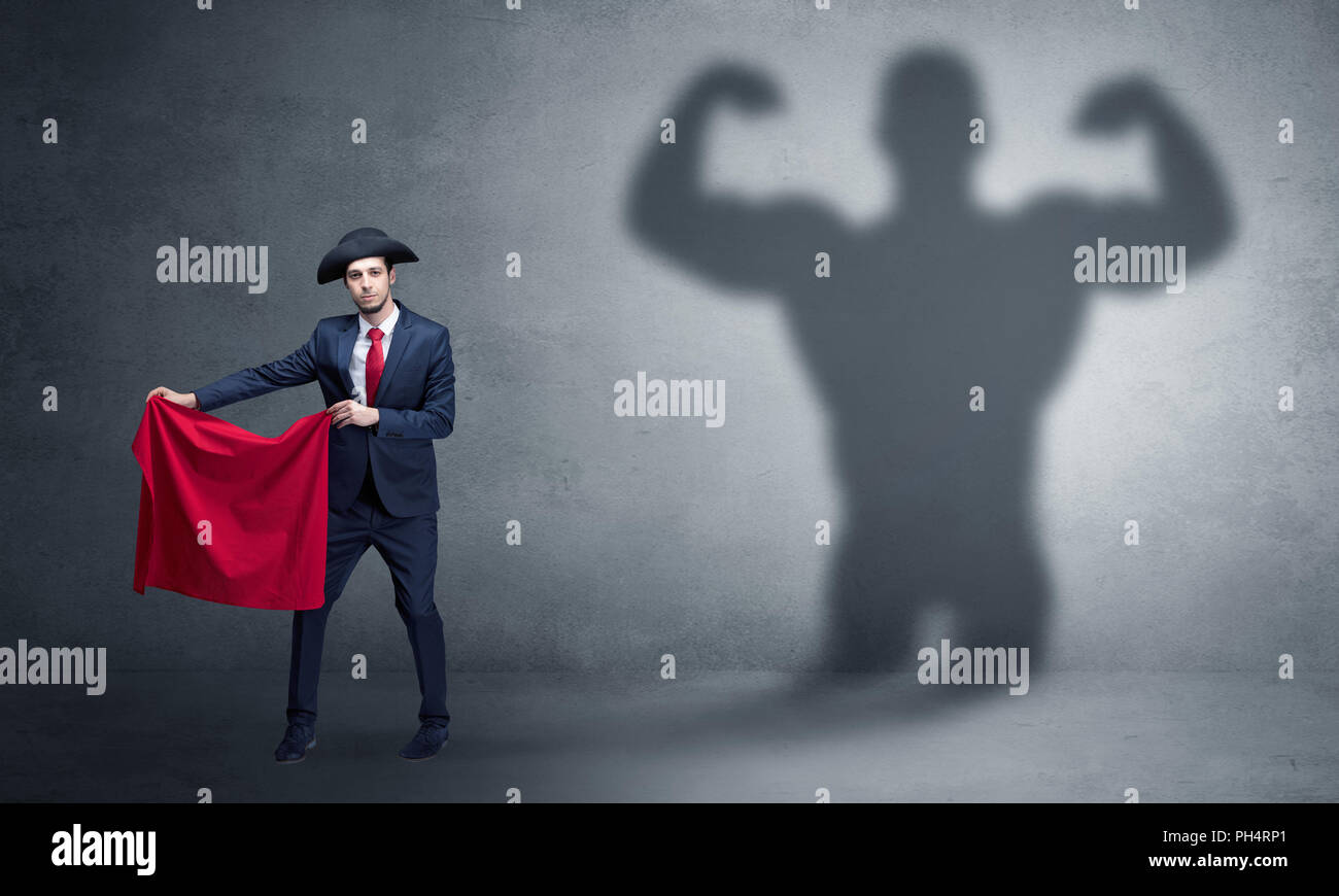 Businessman standing with red cloth on his hand and strong hero shadow ...