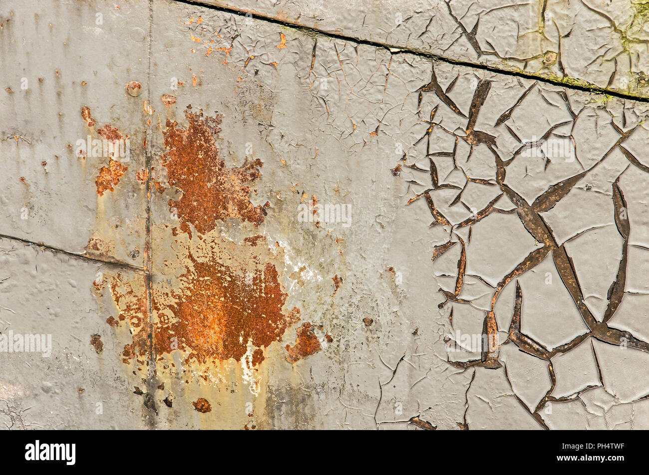 Patches of rust and peeling paint on an old grey hull of a ship Stock ...