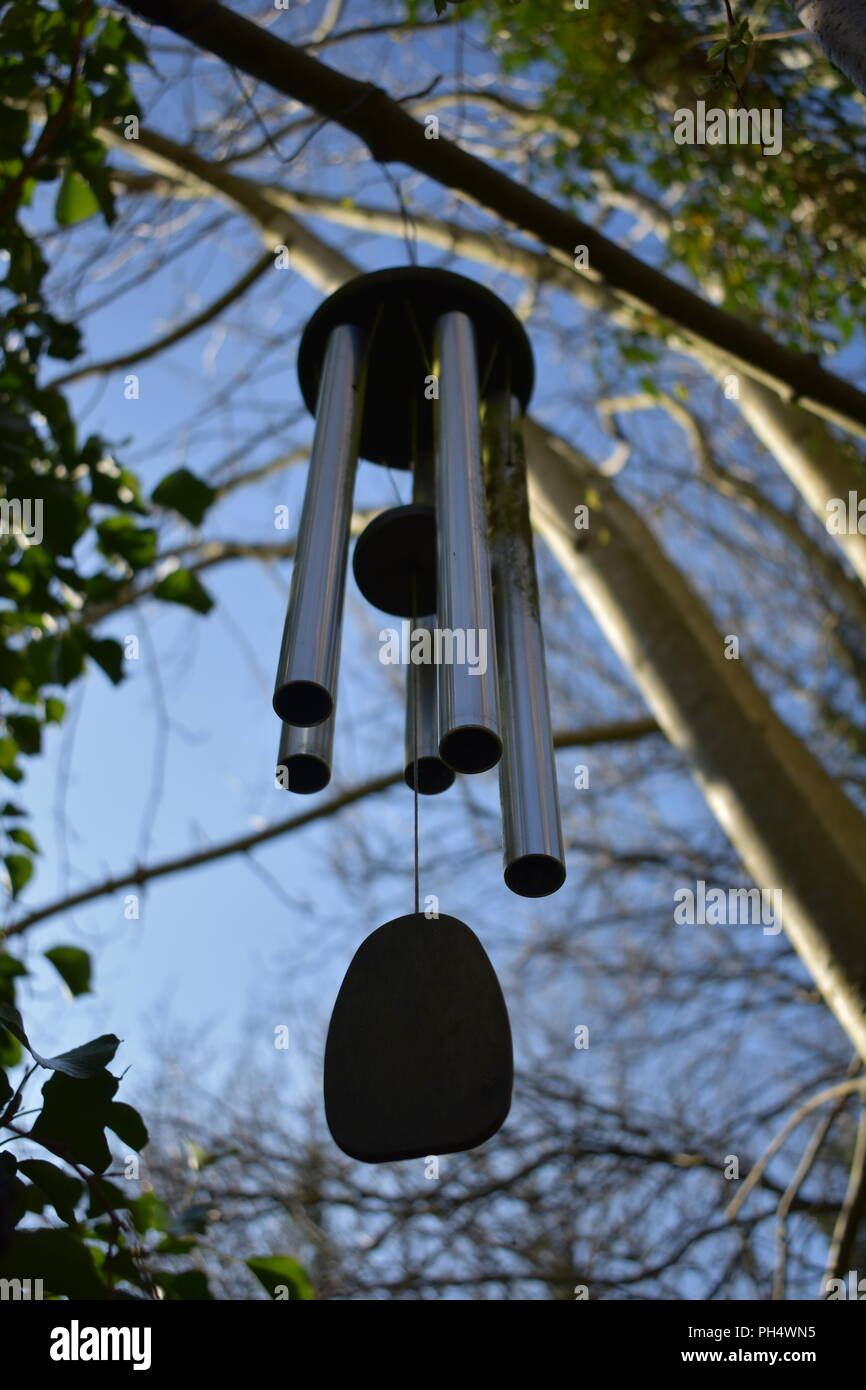 Wind chimes on a tree Stock Photo - Alamy