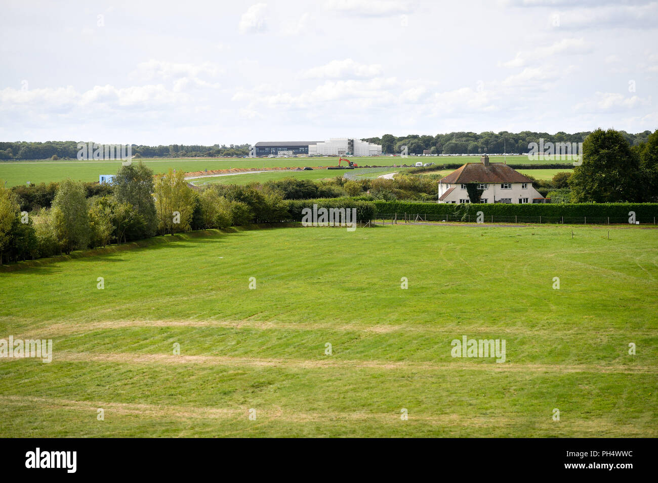 Ongoing work on a hangar, wrapped in white sheeting, at Hullavington ...