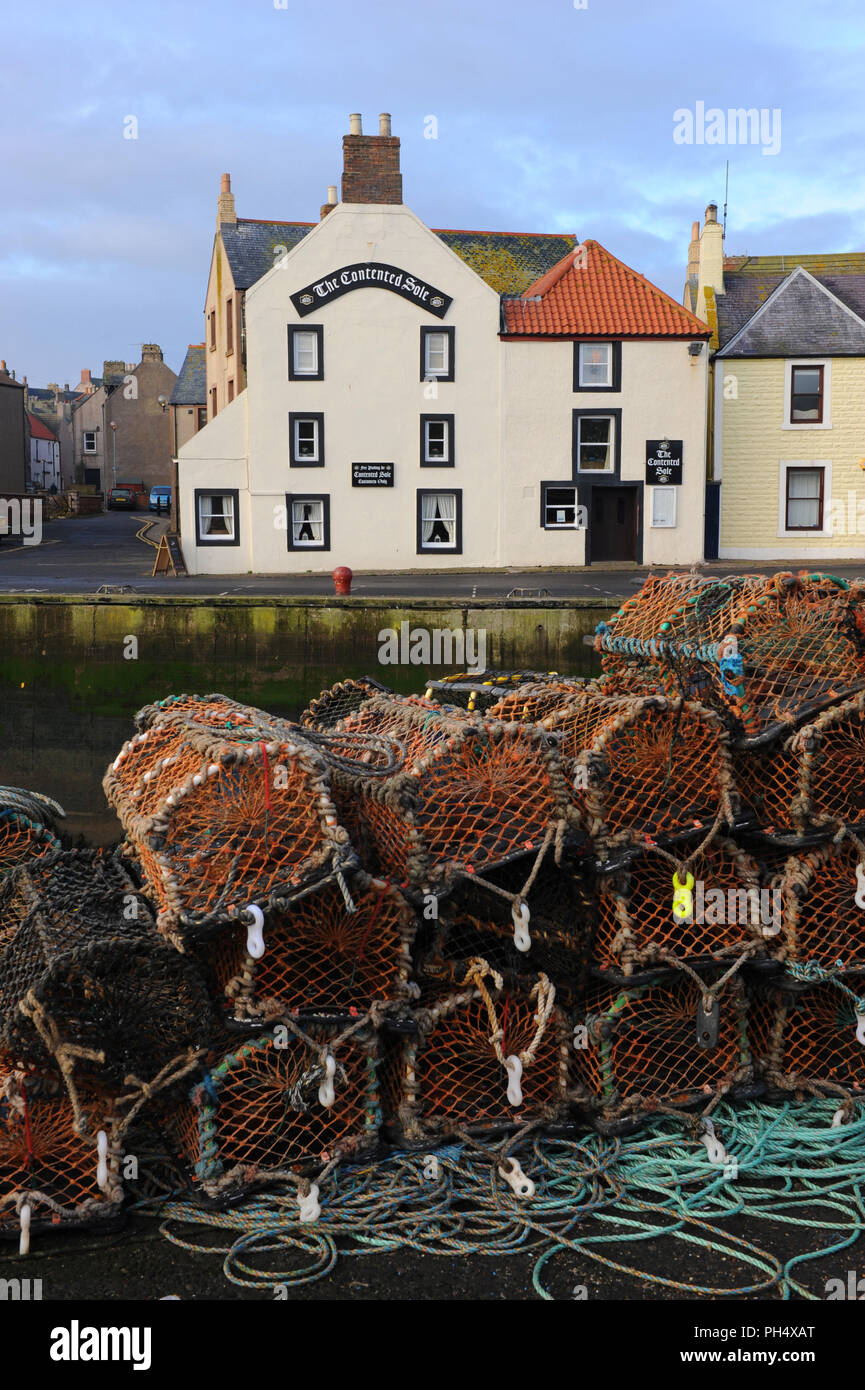 Lobsterpots on the quayside of Eyemouth Harbour, Scotland, UK. The ...