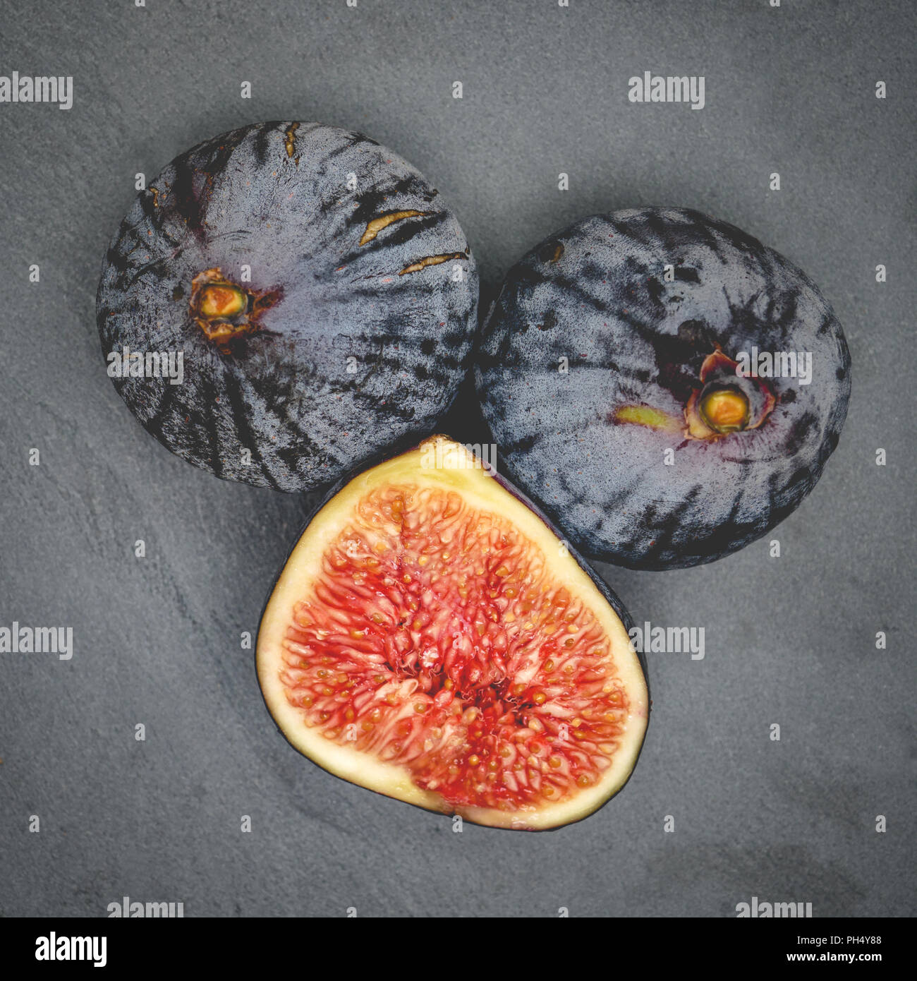 Organic figs in face shape on stone plate, flat lay, matte effect Stock ...