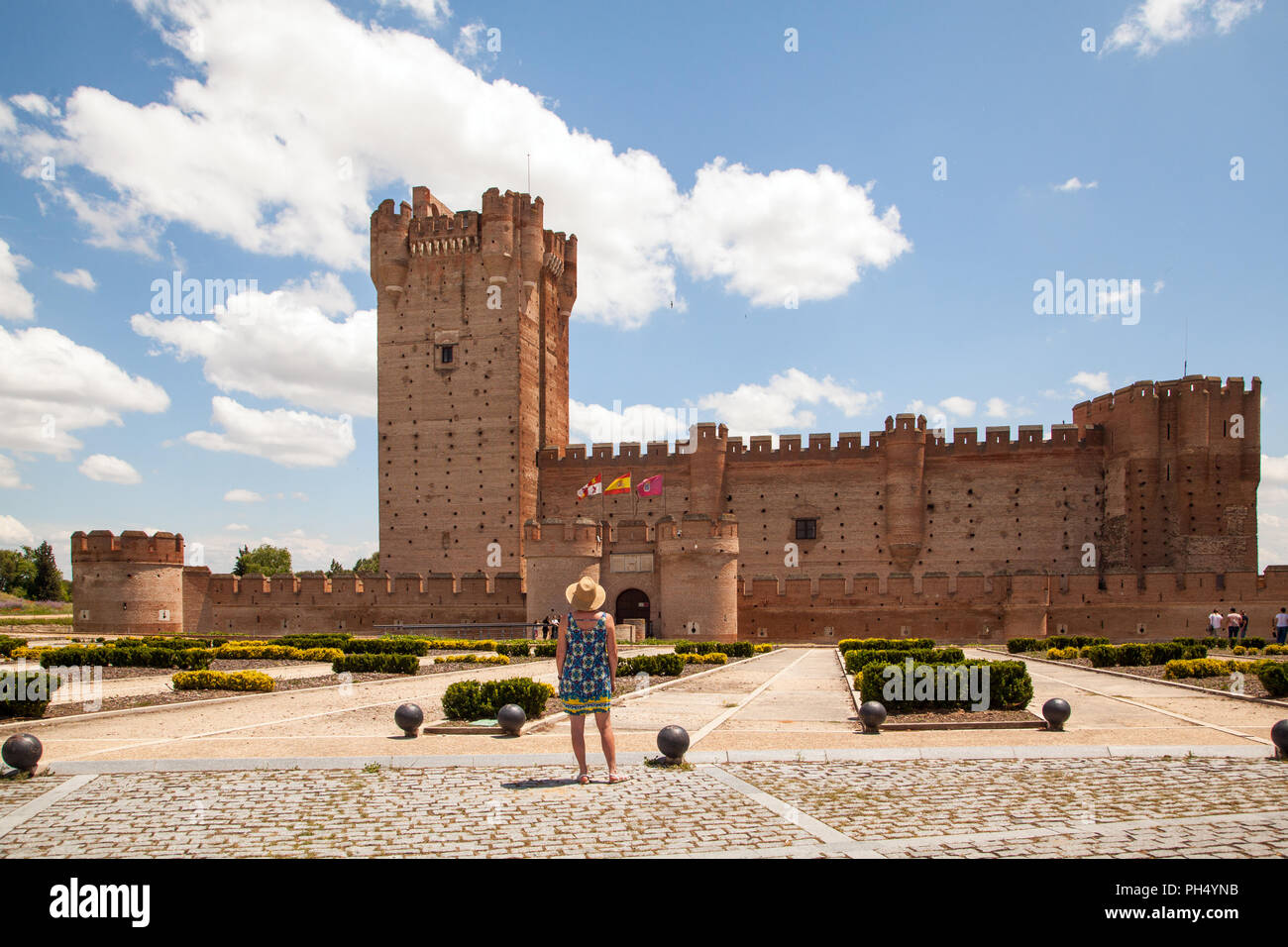 Woman looking at viewing the medieval castle of La Mota in the Spanish ...