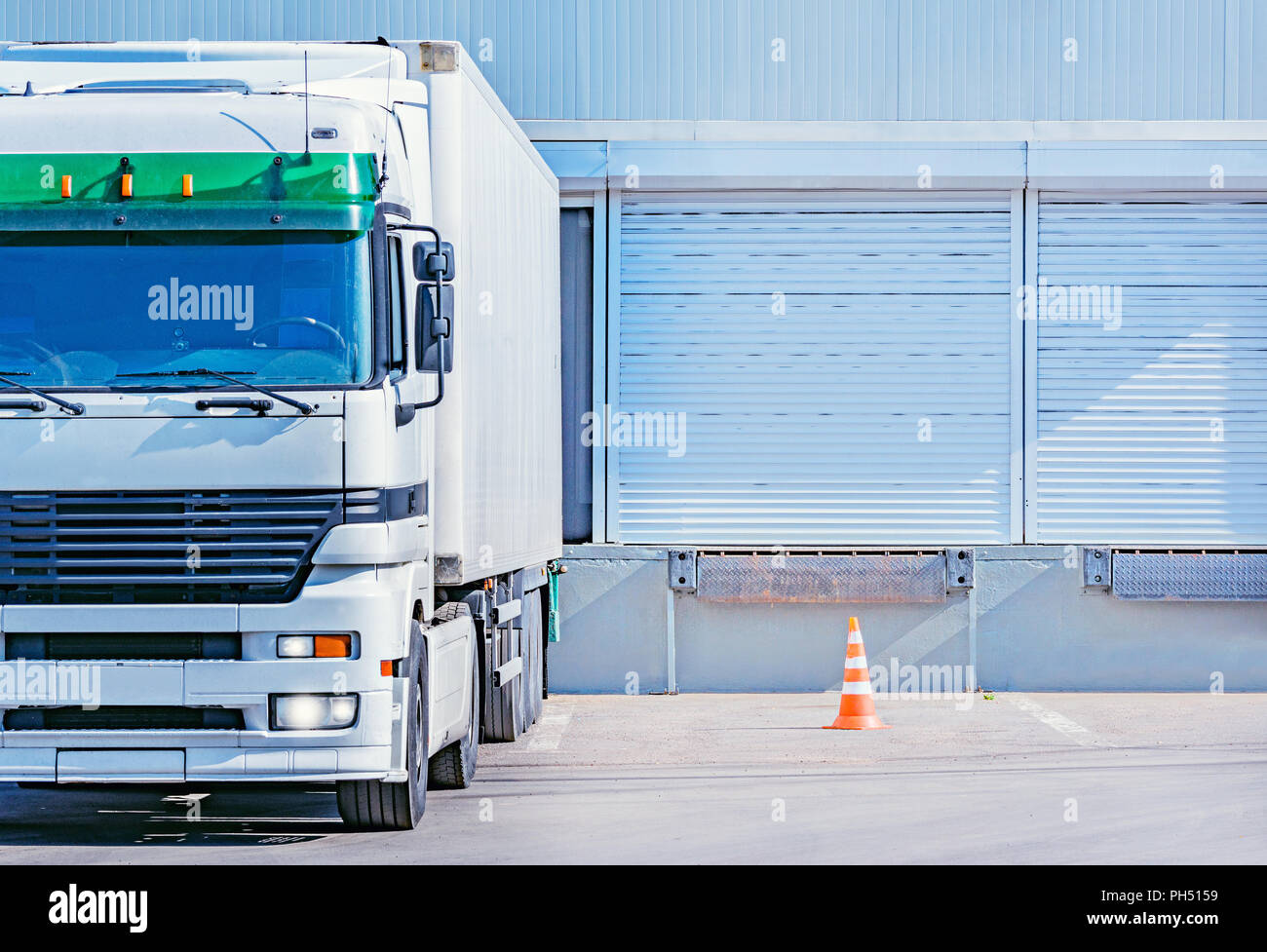 Freight truck stands by the door of the storage Stock Photo - Alamy