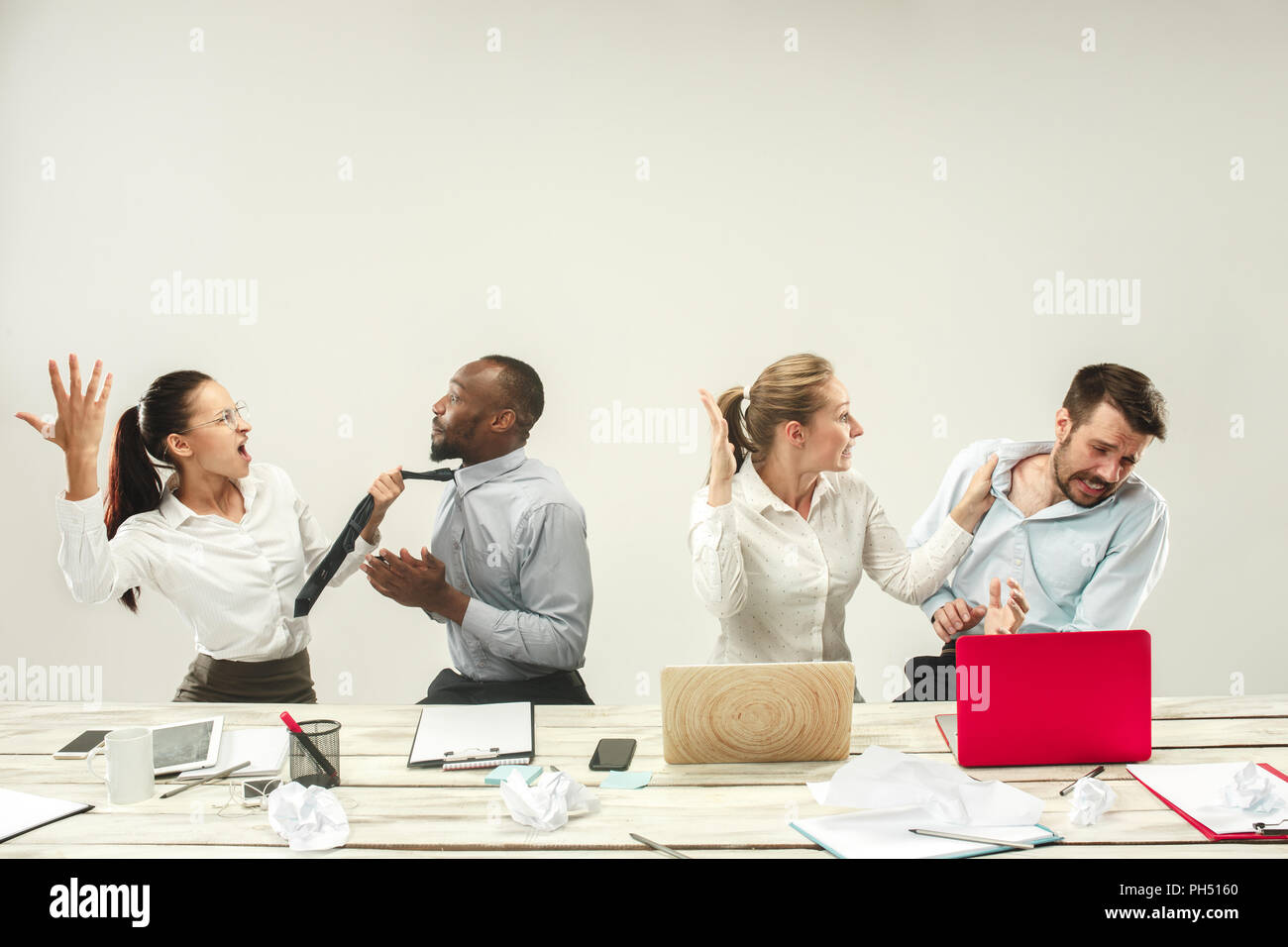 Winners. Young african and caucasian men and women sitting at office ...