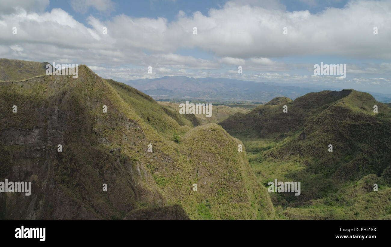 Aerial view of mountains covered with green vegetation, trees in ...