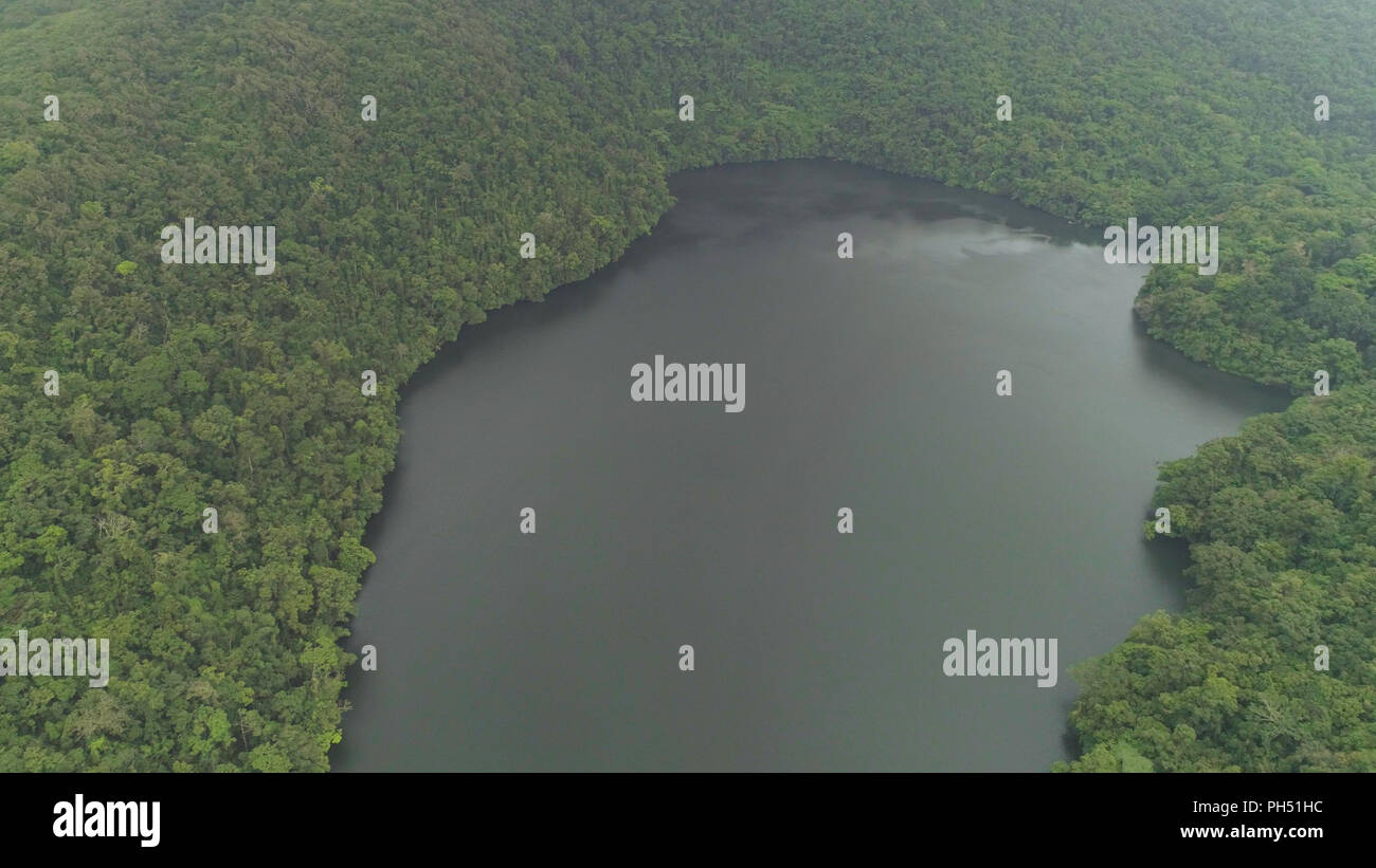 Aerial view of lake Bulusan in the mountains with green rain forest ...