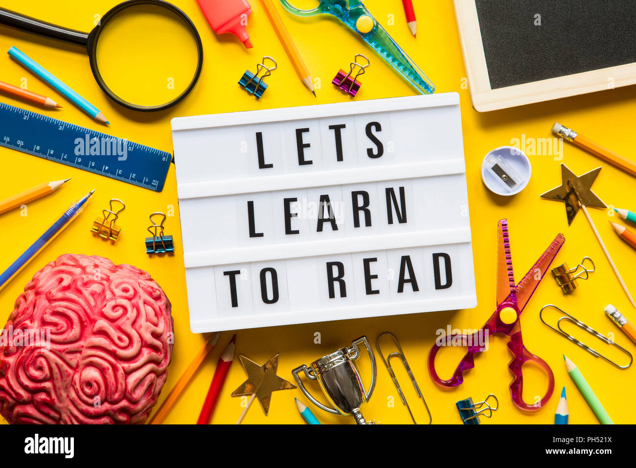 Lets learn to read lightbox message on a bright yellow background Stock ...