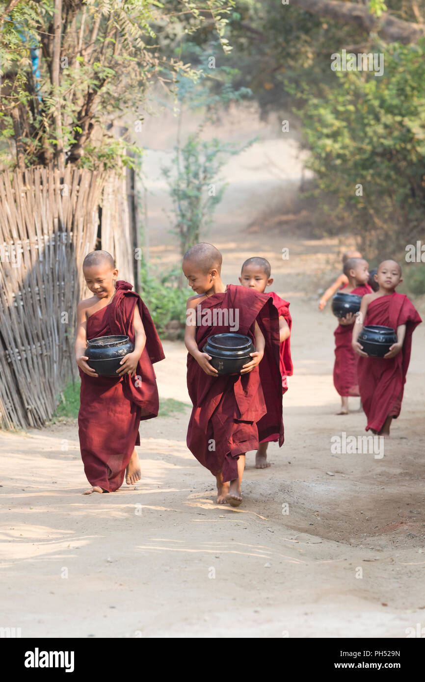 Young monks on their morning alms rounds, Bagan, Myanmar Stock Photo ...