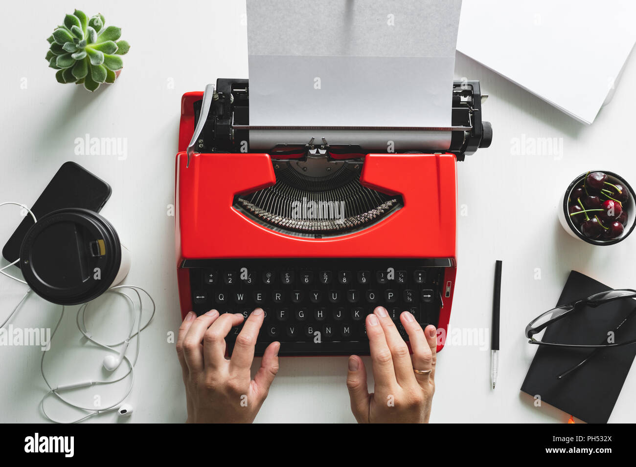 Woman hand working with bright red vintage typewriter Stock Photo - Alamy