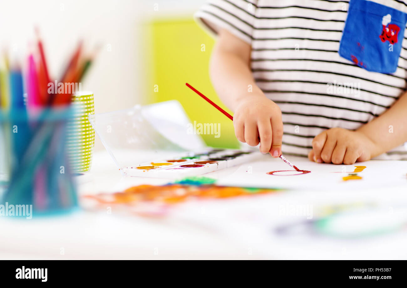 Little child drawing on the paper in room Stock Photo - Alamy