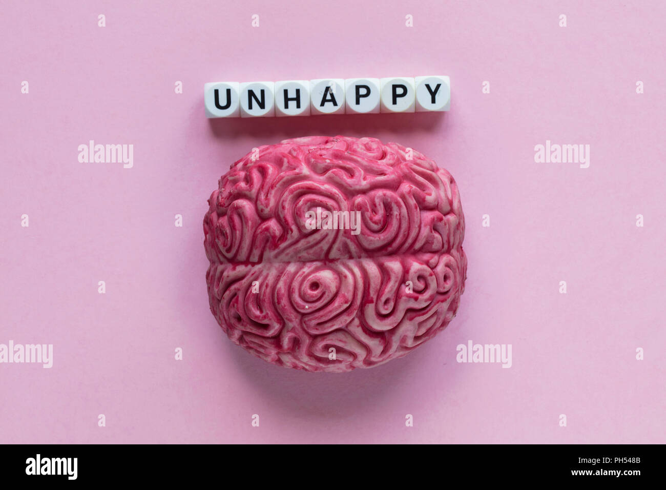 Human brain with the word unhappy. Mental health concept Stock Photo ...