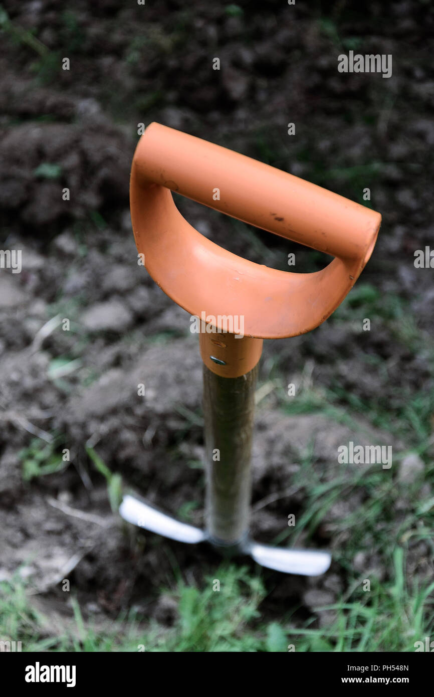 Soil with shovel in garden Stock Photo - Alamy