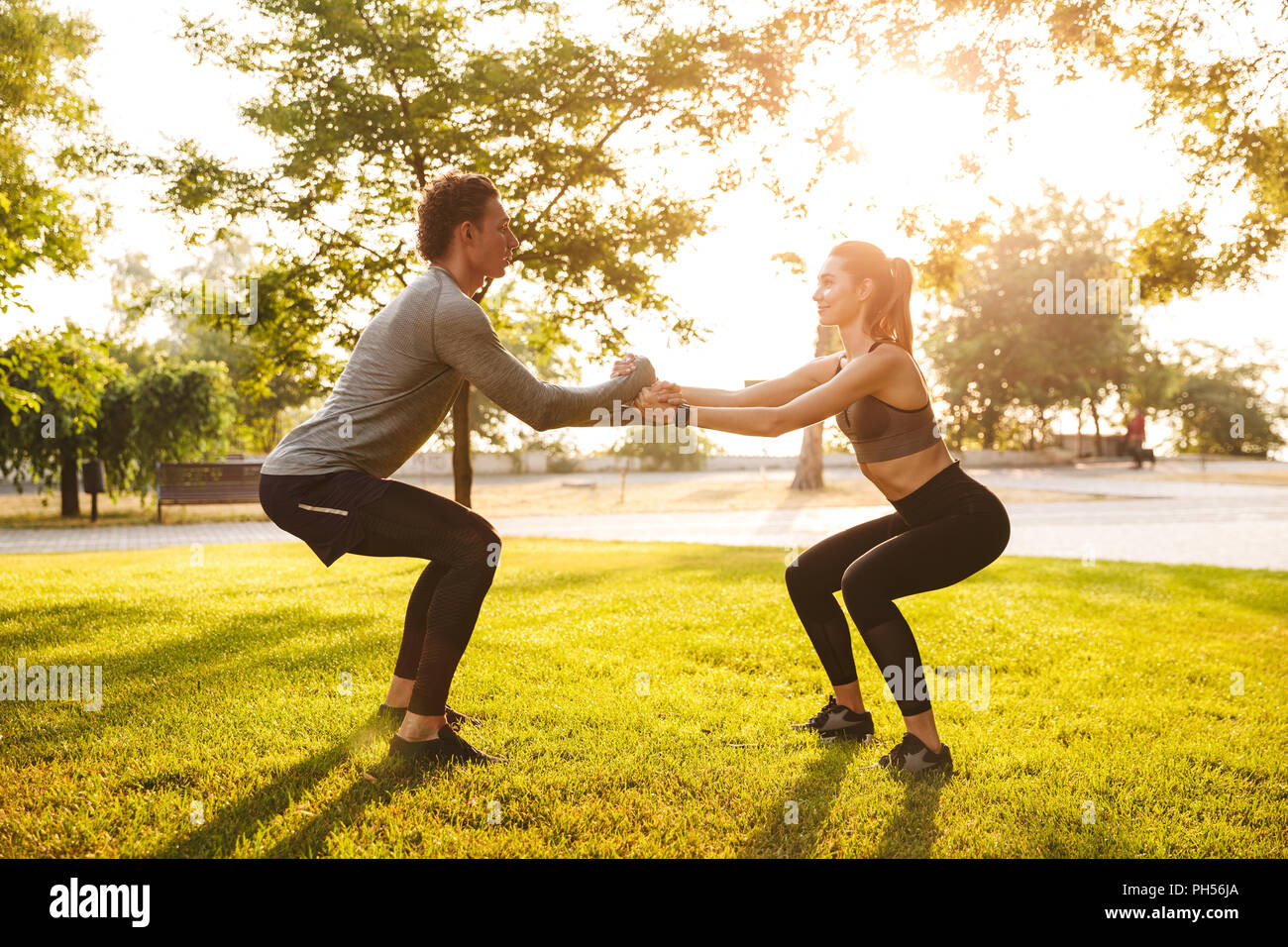 Photo of concentrated fitness sport loving couple friends in park ...