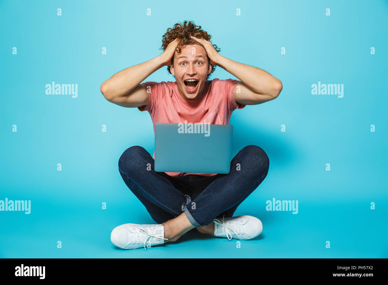 Image of hipster man 20s with brown curly hair grabbing head, while ...