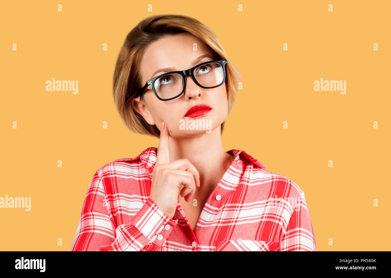 Young thinking business woman with questioning face expression looking ...