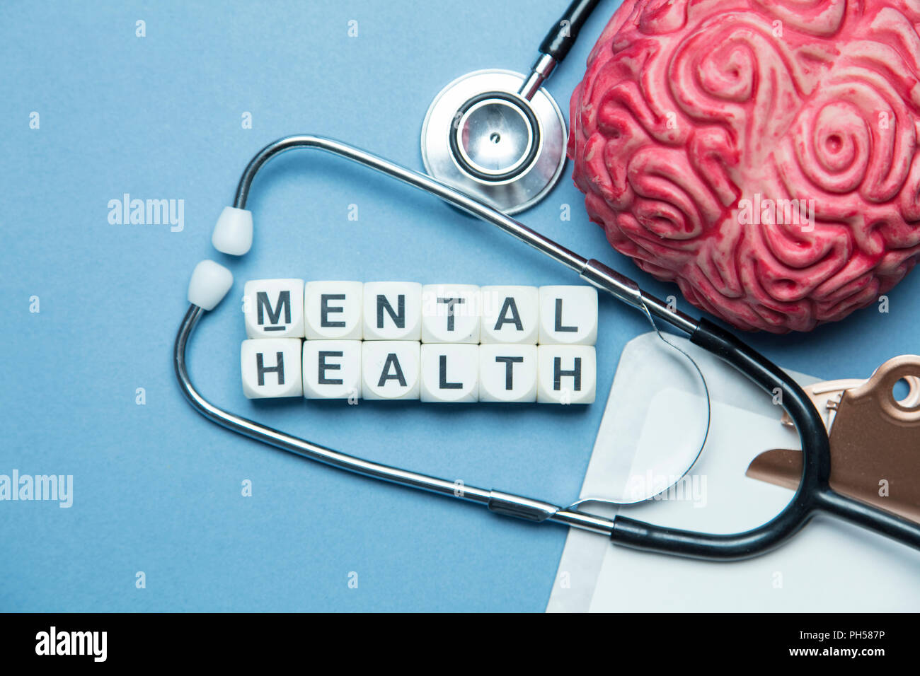 Mental health concept. human brain on a blue background Stock Photo - Alamy