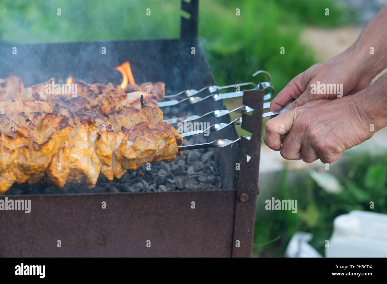 Cooking hot pork on russian barbecue, prepared on grill with spices ...