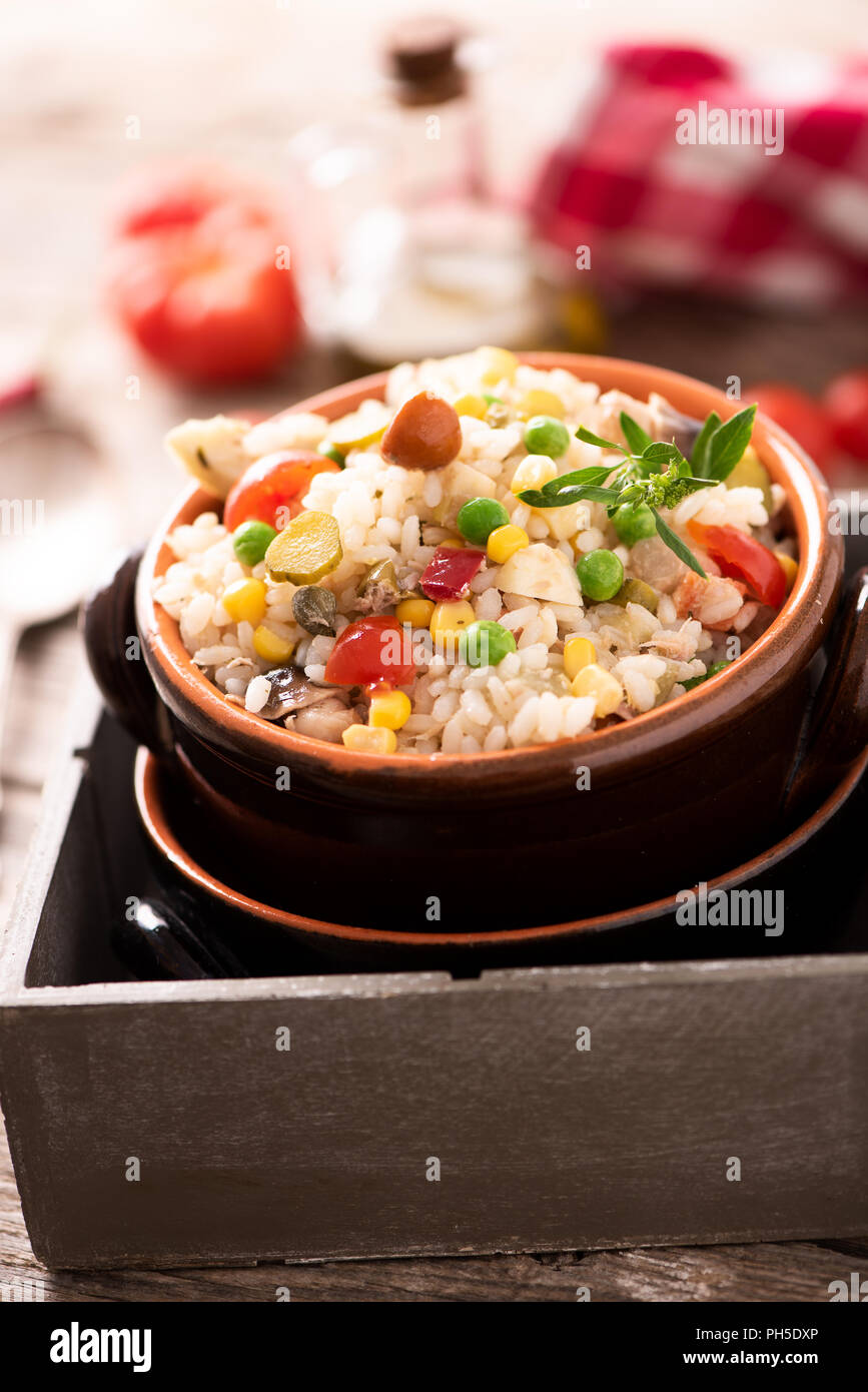 Traditional italian rice salad on wood table Stock Photo - Alamy