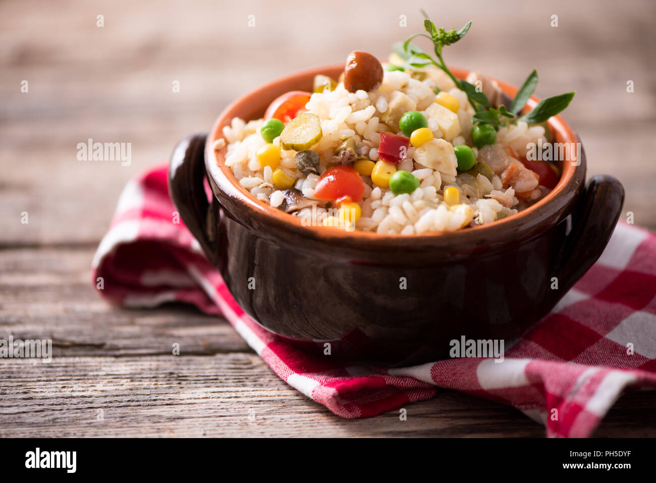 Traditional italian rice salad on wood table Stock Photo - Alamy