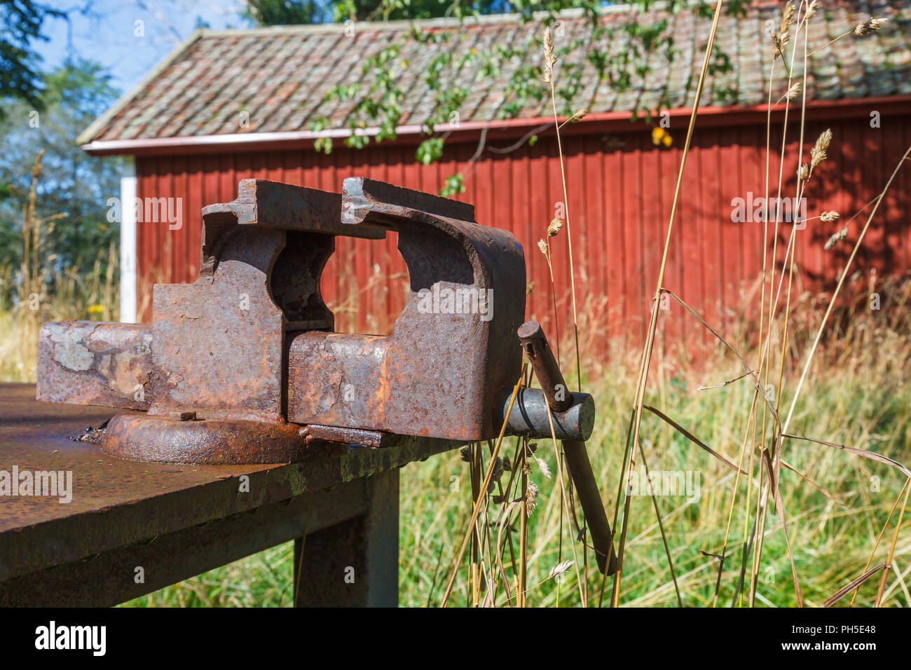 Workbench with a rusty vise outdoors Stock Photo - Alamy