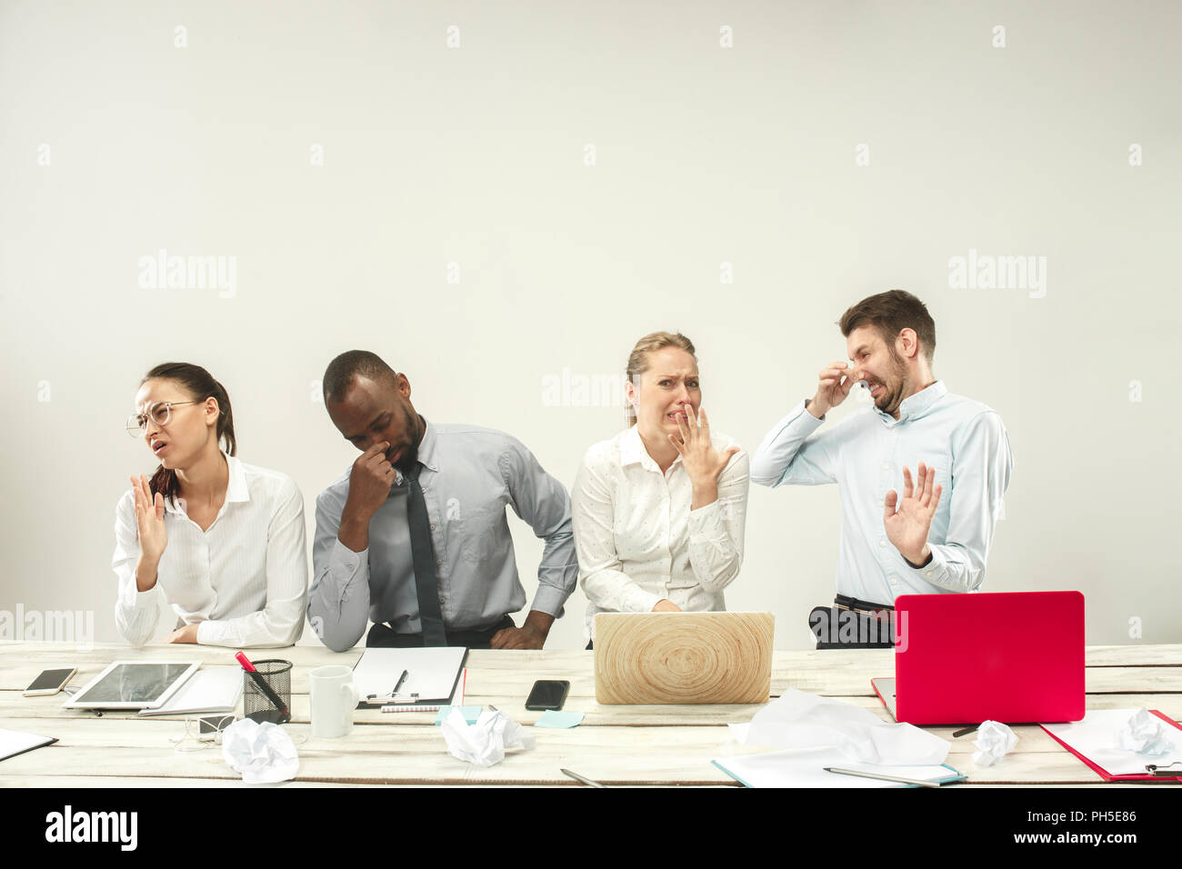 disgust. Young upset african and caucasian men and women sitting at ...