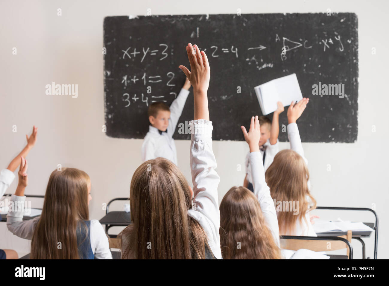 School children in classroom at lesson. The little boys and girls ...