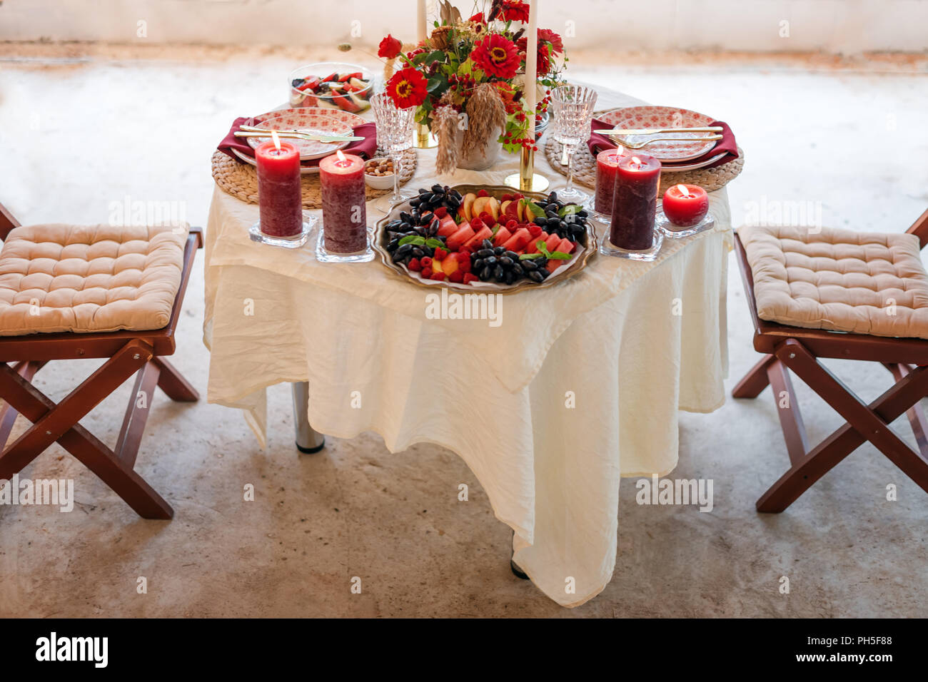 Luxury table settings for fine dining with candles and glassware ...