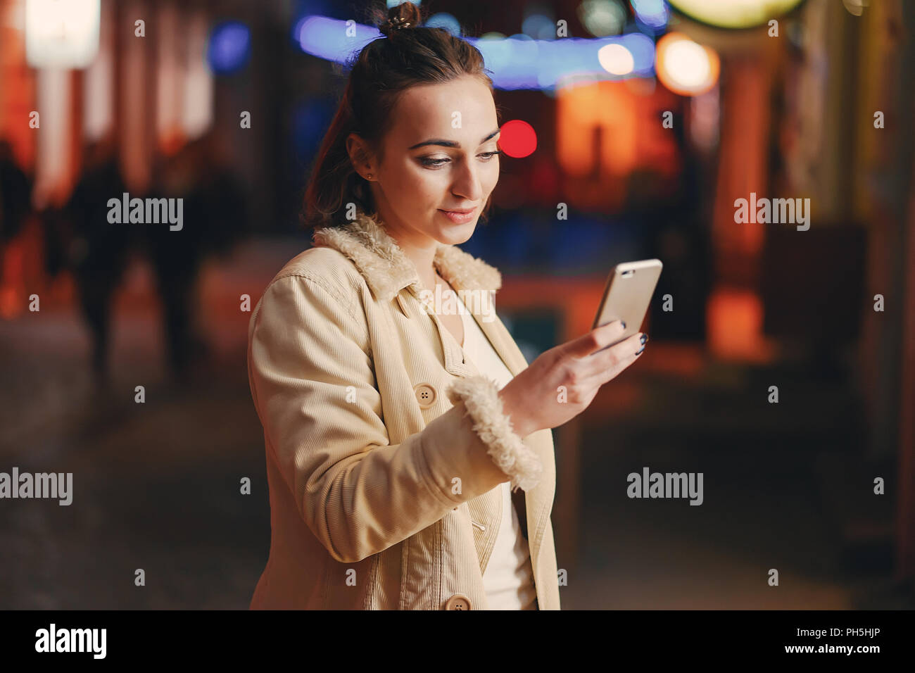 girl checking her phone outside at night Stock Photo - Alamy