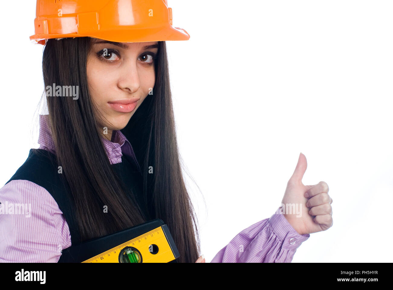 Attractive girl with level shows thumb up gesture Stock Photo - Alamy
