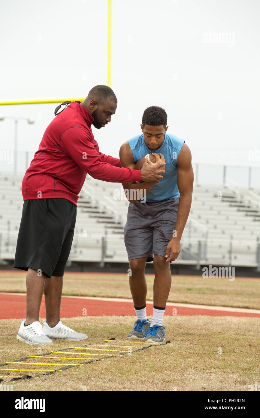 Coach training a high school athlete Stock Photo - Alamy