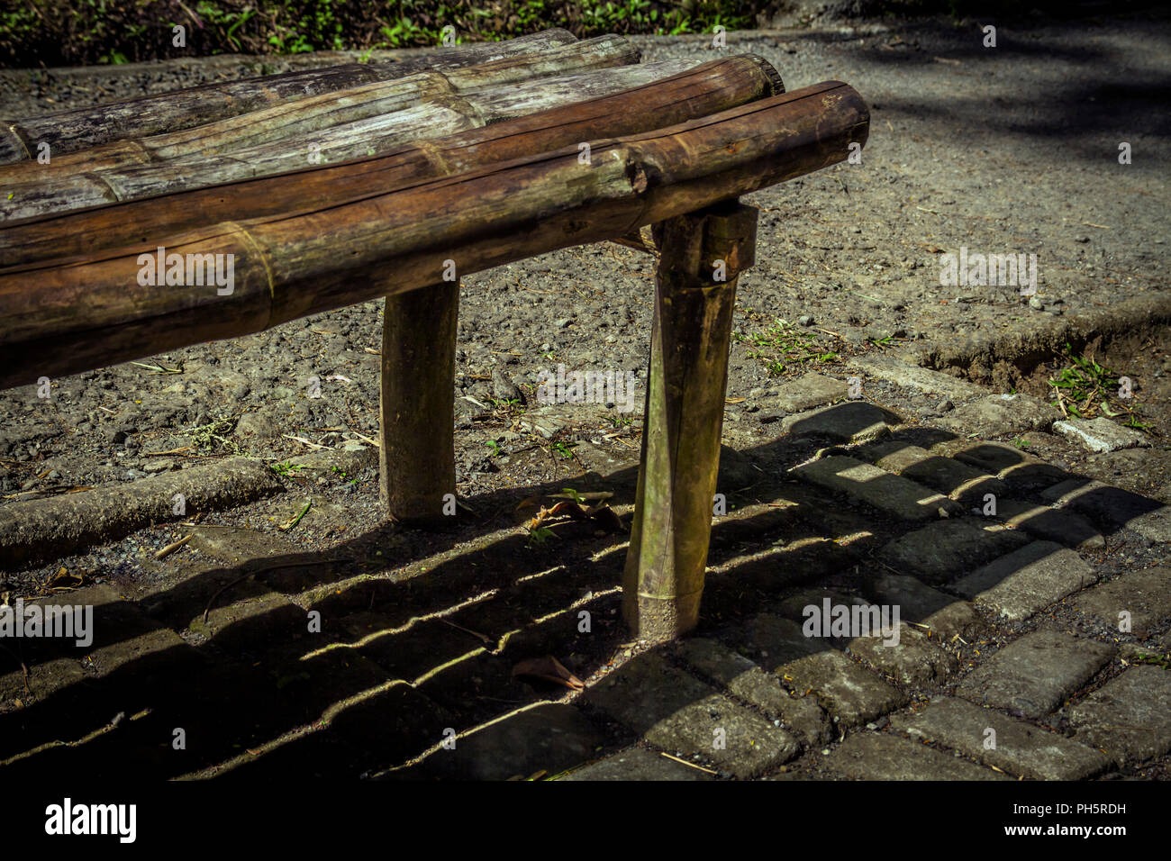 A traditional bamboo bench beside the footpath Stock Photo - Alamy