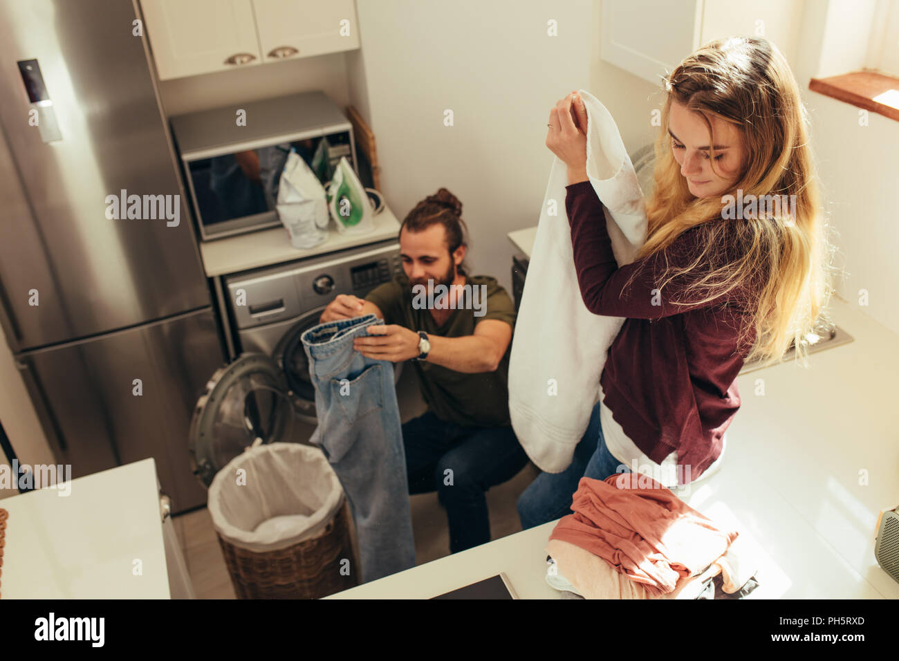Woman folding laundry folding clothes hi-res stock photography and ...