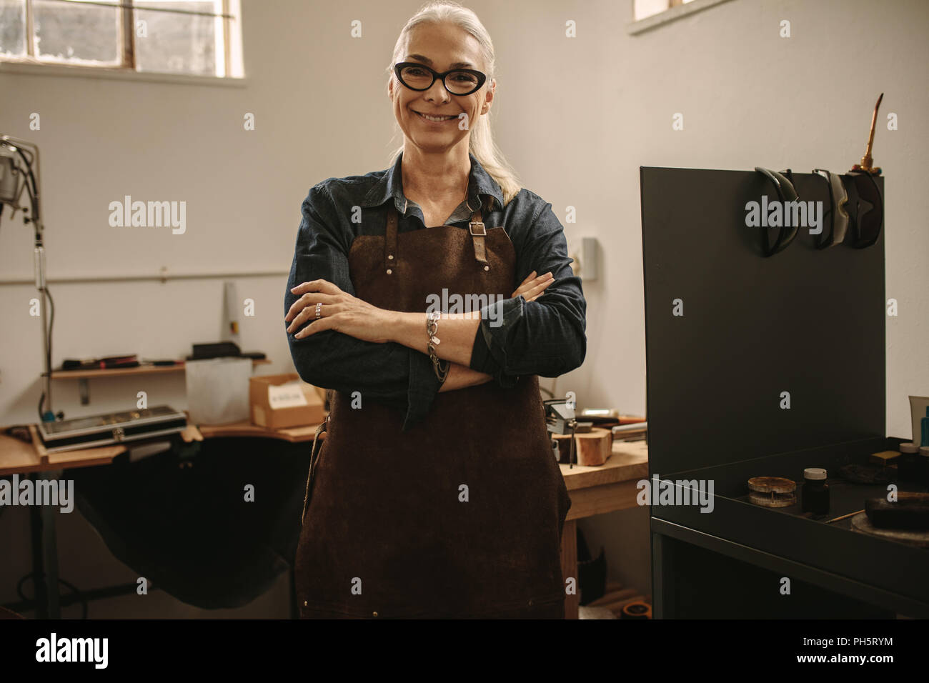 Portrait confident goldsmith standing arms hi-res stock photography and ...