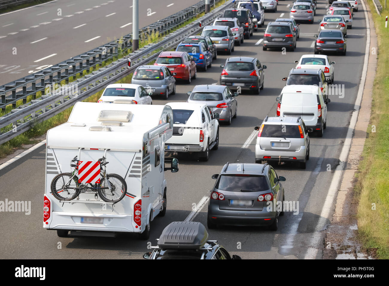 Rear view of traffic jam of lined up cars stuck on the highway toll ...