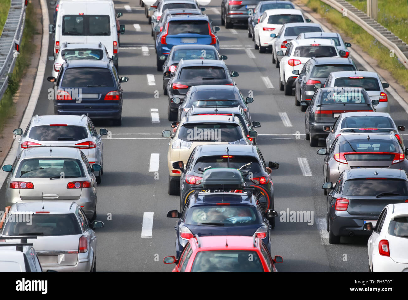 Rear view of traffic jam of lined up cars stuck on the highway toll ...