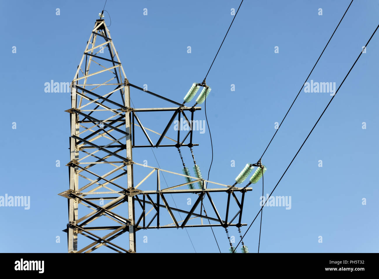 Electric pylon against the backdrop of the blue sky on a summer day ...