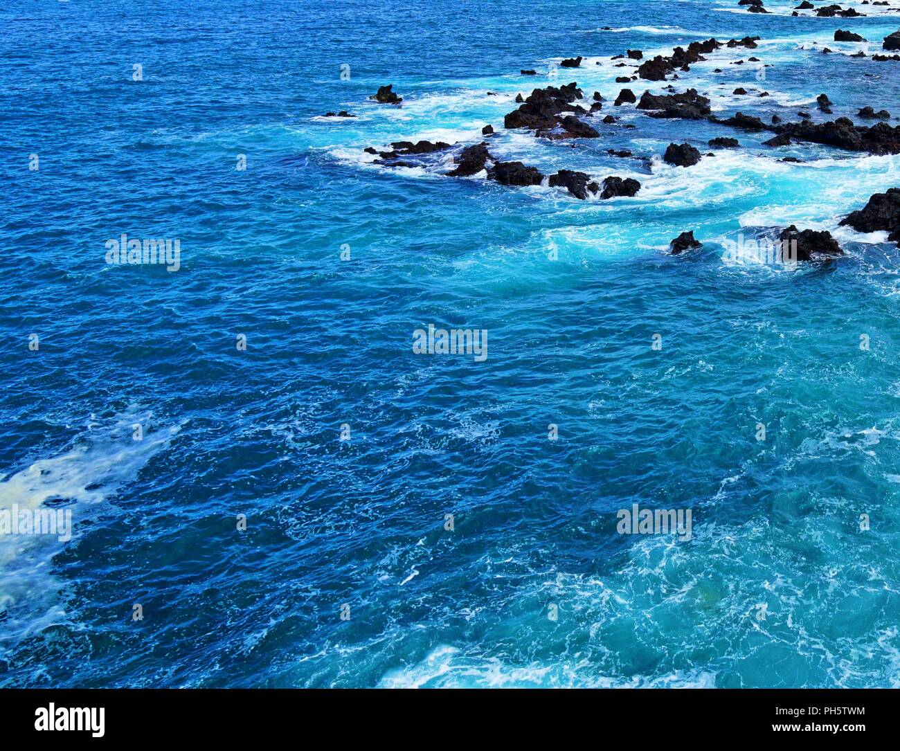 blue ocean water, waves with rock reef in background, Tenerife Stock ...