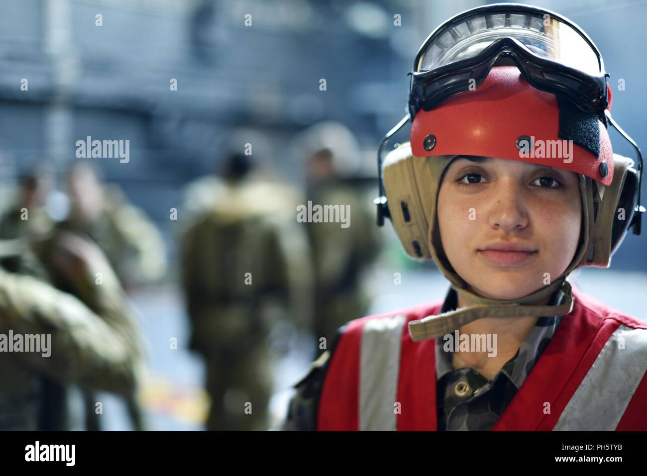 An Australian Royal Navy member prepares to escort soldiers to the ...