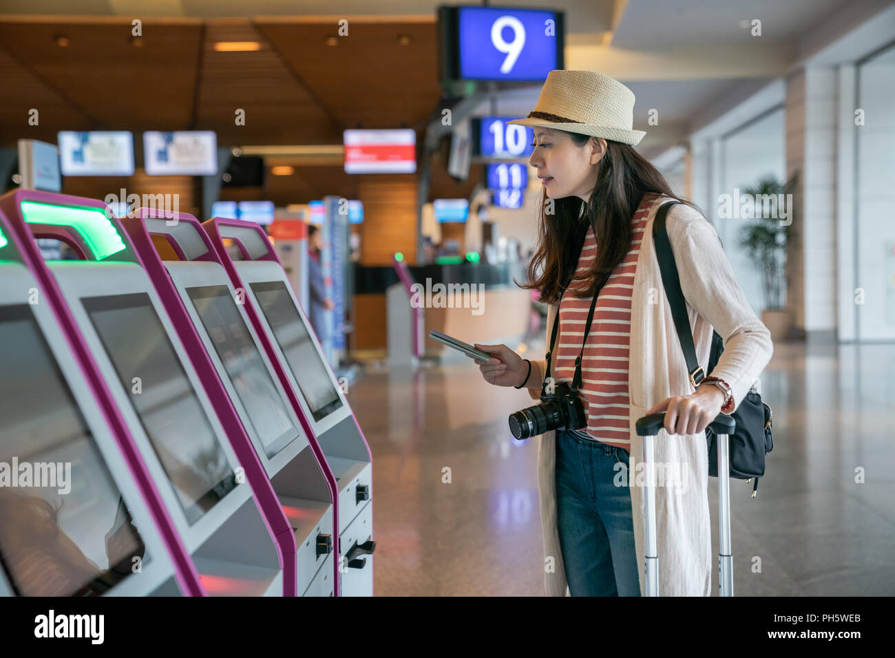 visitor standing at the self-check-in machine. view from side Stock ...