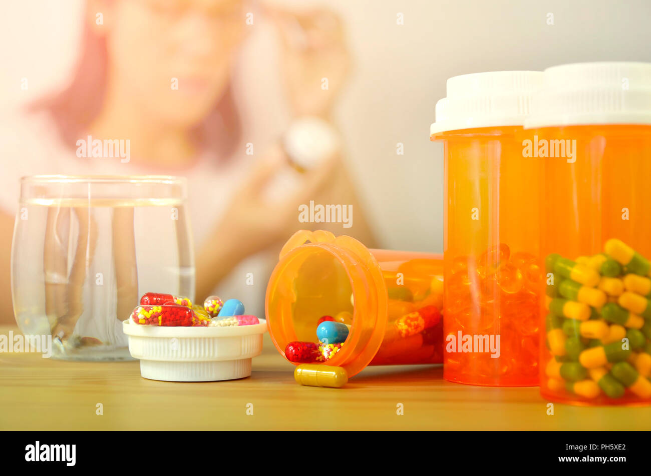 Medicine, light protected container and a glass of water with ...