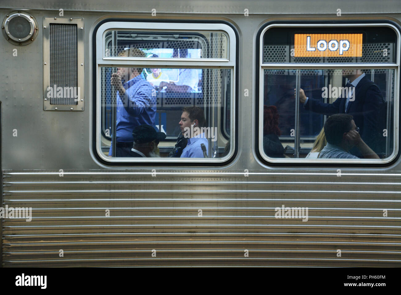 Commuters take a crowded El train to work in the Loop on Chicago's ...